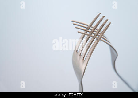 Two interlaced forks. Close view Stock Photo - Alamy
