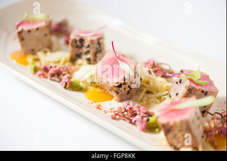 Modern style Japanese food, Burned tuna with herbs isolated on white ...