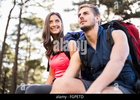 Young happy joggers sitting on rock and looking at camera Stock Photo ...