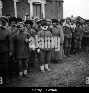 A group of Soviet prisoners of war is taken by German soldiers into a ...