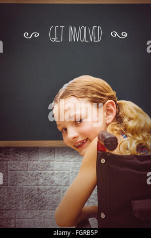 Portrait of schoolgirl sitting against chalkboard Stock Photo - Alamy