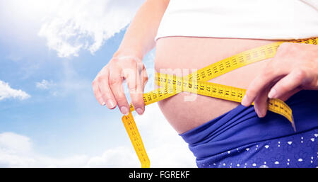 Pregnant woman measuring her bump Stock Photo - Alamy