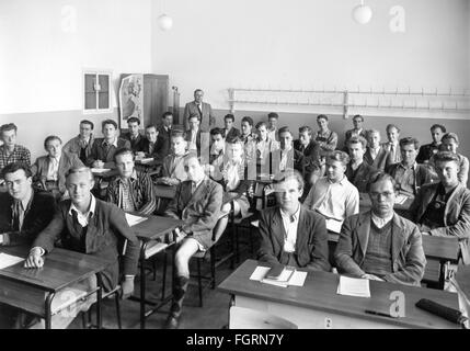 1950s, historical, school classroom, male teacher in traditional gown ...