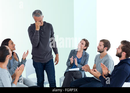 Composite image of rehab group applauding delighted woman standing up ...