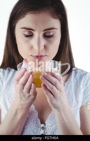 pretty, young woman smelling cut bell pepper while standing at kitchen ...
