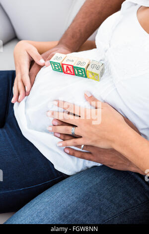Midsection of pregnant woman belly with toy Stock Photo - Alamy