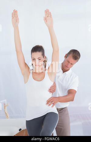 Female doctor and a mature man raising crutches and recovering from ...