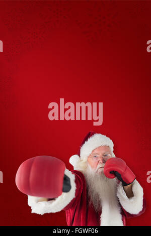 Composite image of santa claus punches with his right Stock Photo - Alamy