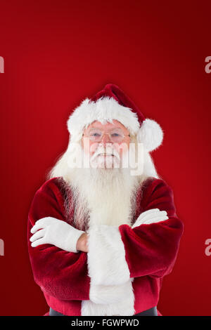 Composite image of santa smiles with folded arms Stock Photo - Alamy