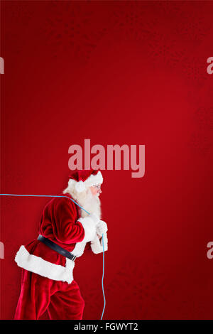 Santa claus pulling a rope Stock Photo - Alamy