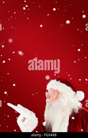 Composite image of santa claus blowing Stock Photo - Alamy