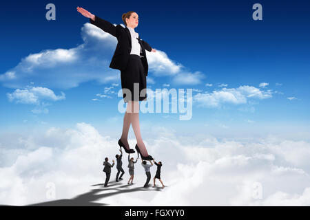 Composite image of business people supporting boss Stock Photo - Alamy