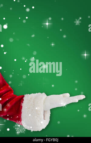 Composite image of santa claus presenting with hand Stock Photo - Alamy