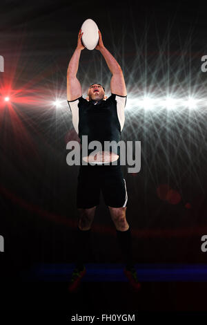 Composite image of rugby player catching the ball Stock Photo - Alamy