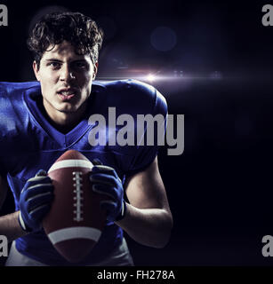 Composite image of aggressive american football player in red jersey ...