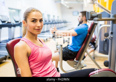 Fit people using weights machines Stock Photo - Alamy