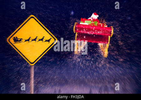Composite image of christmas road sign Stock Photo - Alamy