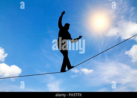 Businessman balancing on tightrope on the line chart Stock Photo - Alamy