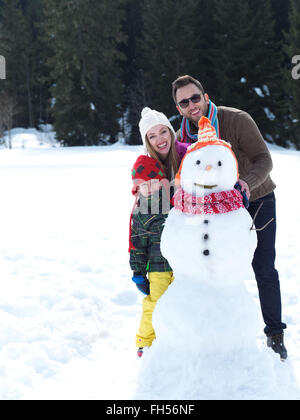 happy family making snowman Stock Photo - Alamy
