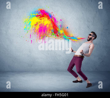 Hipster guy shouting colorful paint on wall Stock Photo - Alamy