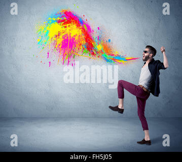 Hipster guy shouting colorful paint on wall Stock Photo - Alamy