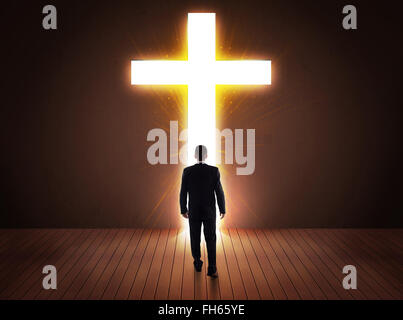 Man looking at bright cross sign Stock Photo - Alamy