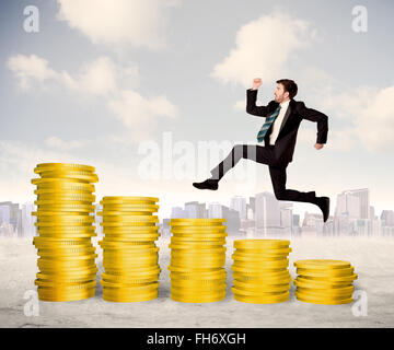 Successful business man jumping up on gold coin money Stock Photo - Alamy
