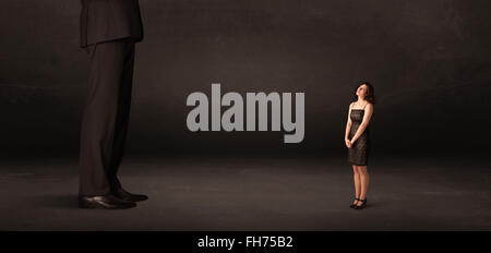 Huge man with small businesswoman standing at front concept Stock Photo ...