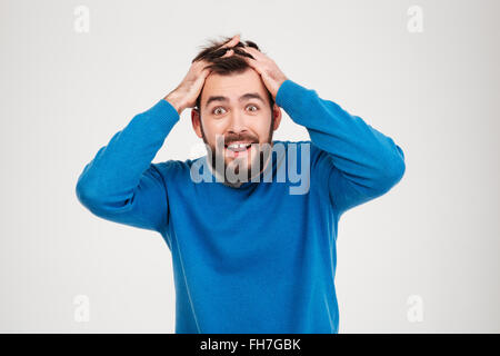 Portrait of handsome cheerful amazed guy demonstrating copy space new ...
