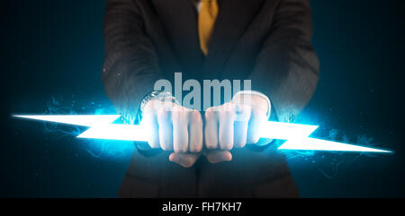 Business man holding glowing lightning bolt in his hands Stock Photo ...