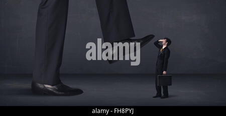 Giant person stepping on a little businessman concept Stock Photo - Alamy