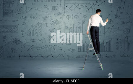 Man on ladder drawing charts Stock Photo - Alamy