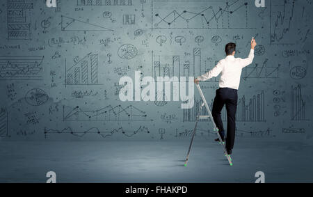 Man on ladder drawing charts Stock Photo - Alamy