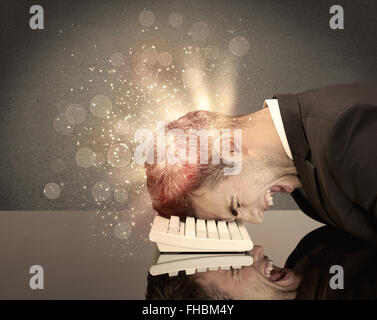 Angry businessman with lights and keyboard Stock Photo - Alamy