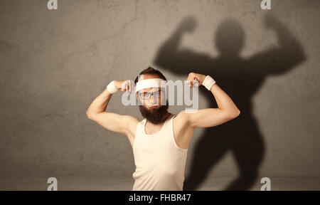 Skinny man with musculous shadow Stock Photo - Alamy
