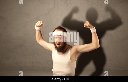 Skinny man with musculous shadow Stock Photo - Alamy