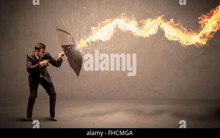 Businessman defending with umbrella from CLOUD GAMING inscription ...