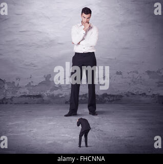 Angry big manager looking at small business man Stock Photo - Alamy
