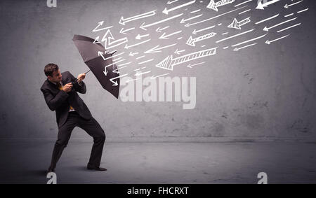 Business man standing with umbrella and drawn arrows hitting him Stock ...