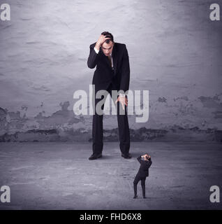 Angry big manager looking at small business man Stock Photo - Alamy