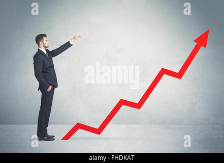 Climbing on red graph arrow Stock Photo - Alamy