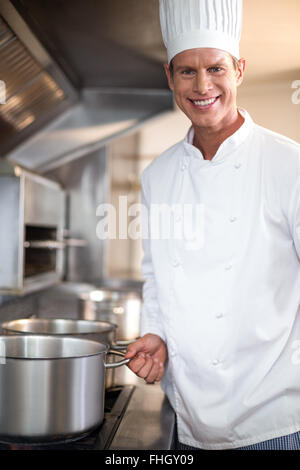 happy smiling male chef with saucepan cooking food Stock Photo - Alamy