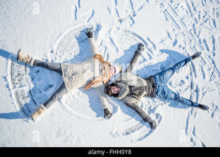 Woman doing snow angel Stock Photo - Alamy