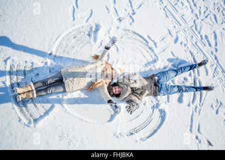 Couple doing snow angel Stock Photo - Alamy
