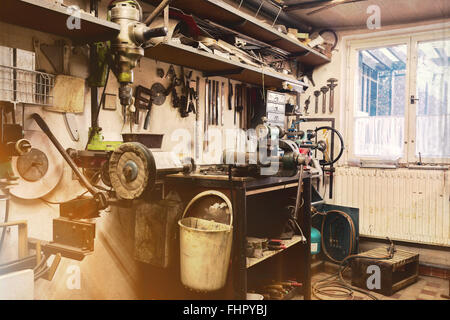 Home maintenance - An untidy workbench full of dusty old tools and ...