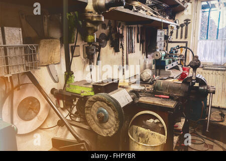 Home maintenance - An untidy workbench full of dusty old tools and ...