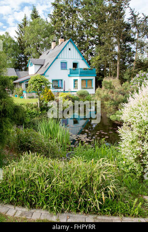 Beautiful luxury house situated in in spring garden, with conifers ...