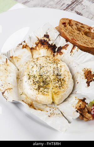 Eating hot baked camembert cheese with grissini sticks. Stretching ...
