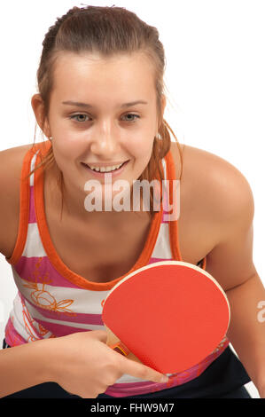 Young teenager girl playing ping pong. She holds a ball and a racket in ...