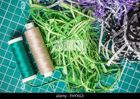 Textile offcuts on checkered green cutting mat Stock Photo - Alamy